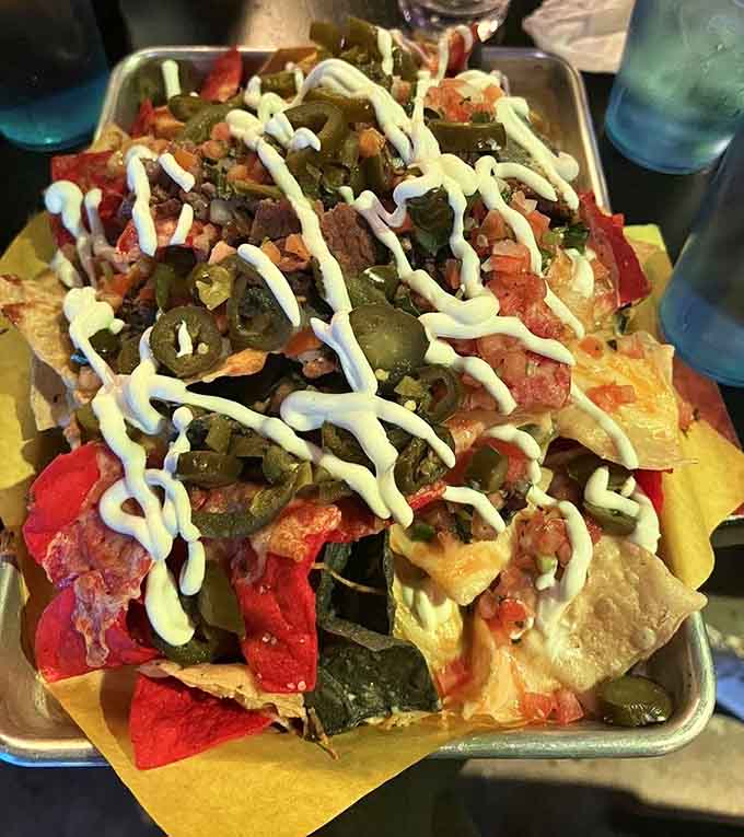 Carne asada nachos piled high enough to fuel a serious gaming marathon, no apologies necessary for the mess.