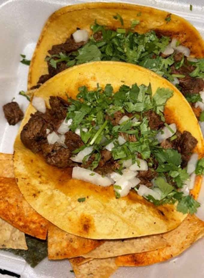 Fresh cilantro, perfectly seasoned carne asada, and corn tortillas: simplicity executed to absolute perfection.