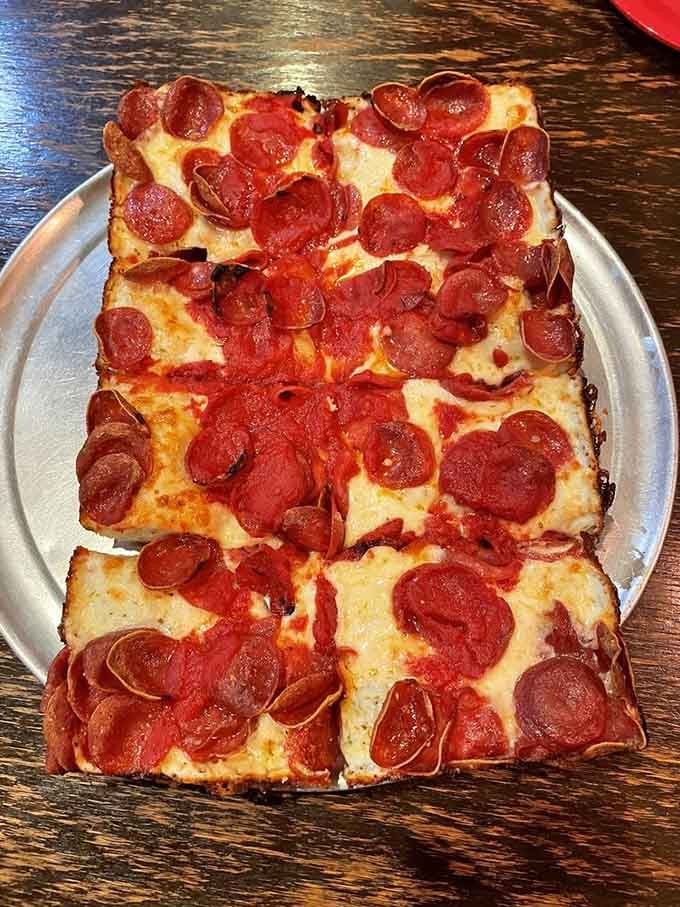 Pepperoni curling at the edges, cheese caramelized to golden perfection &ndash; this is Detroit-style pizza in its purest form.
