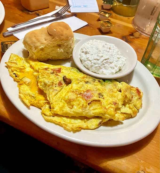 The avocado, bacon, tomato, and cheese omelet arrives with a biscuit that could double as a fluffy pillow.