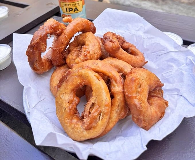These golden onion rings could make a vegetarian reconsider their life choices&mdash;crispy, hand-battered perfection on a plate.