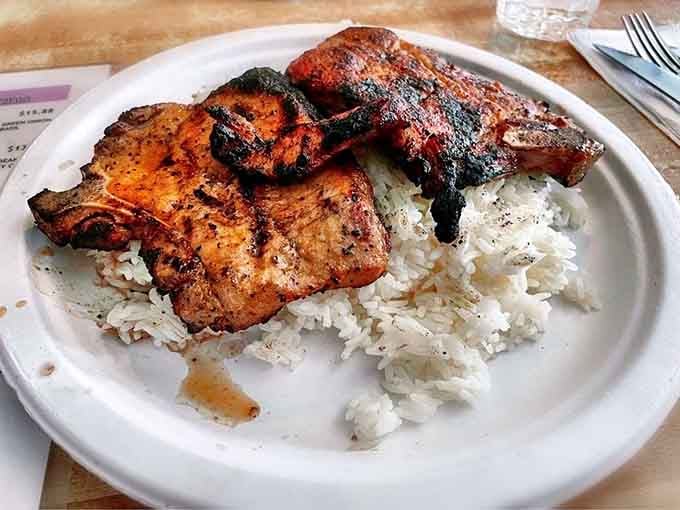 Grilled pork chops with that perfect char sitting on fluffy rice is comfort food that transcends all cultural boundaries.