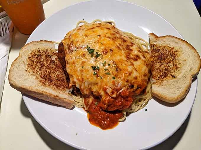 Chicken parmesan so generously portioned it comes with its own toast support system for structural integrity and carb satisfaction.
