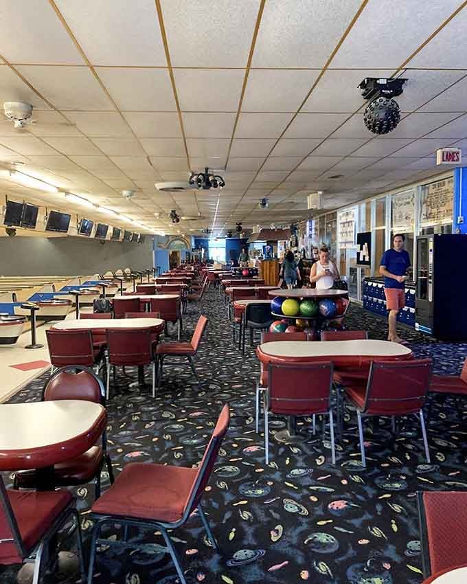 The seating area offers plenty of room to spread out, relax, and enjoy the whole bowling experience.