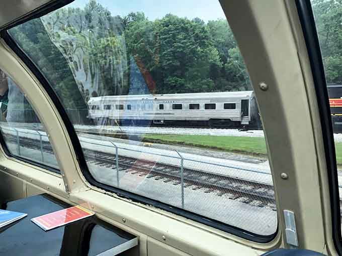 Peek through the dome car window at stored railcars, a behind-the-scenes glimpse of the railroad's impressive collection.