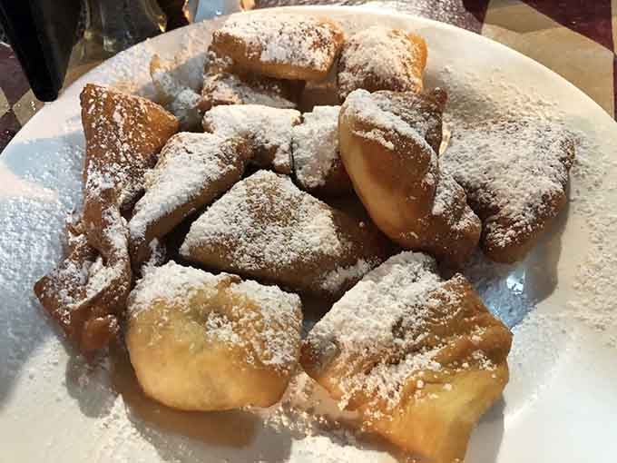 These complimentary fried dough pieces are the opening act that steals the show, crispy outside and cloud-soft within.