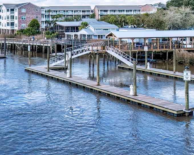 The waterfront docks stretch out like welcoming arms for boats that have stories worth hearing over dinner.