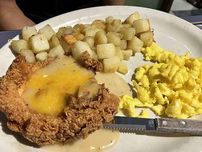Country fried chicken with cheese that's basically a warm hug disguised as breakfast on a plate.