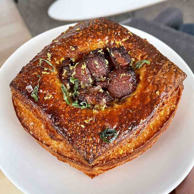 Sweet pork nestled in flaky pastry, glistening like edible treasure that belongs in a culinary museum.