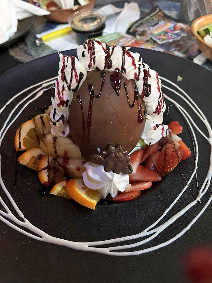 This chocolate dome dessert drizzled with sauces looks like something Fred Flintstone would order for a special occasion celebration.