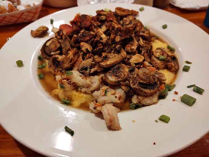 Shrimp and grits topped with mushrooms, proving that Southern comfort food and seafood make the perfect power couple.