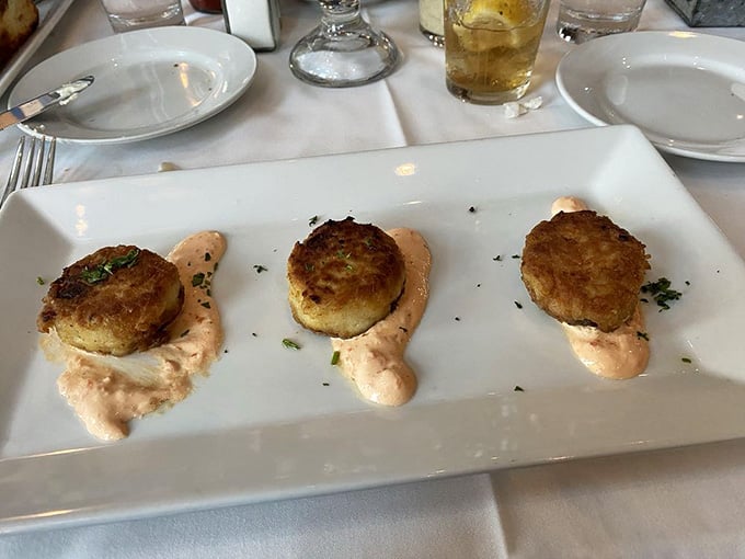 Three golden crab cakes that contain more actual crab than most restaurants use in a week of service.