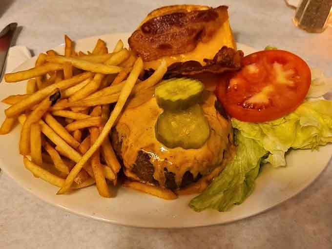 Golden fries, melted cheese, pickles for days, this is what burger dreams look like in real life.