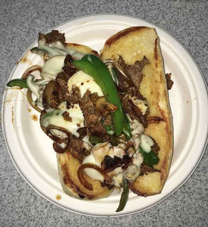 That Philly cheesesteak is loaded with peppers, onions, and enough melted cheese to make Rocky Balboa weep with joy.