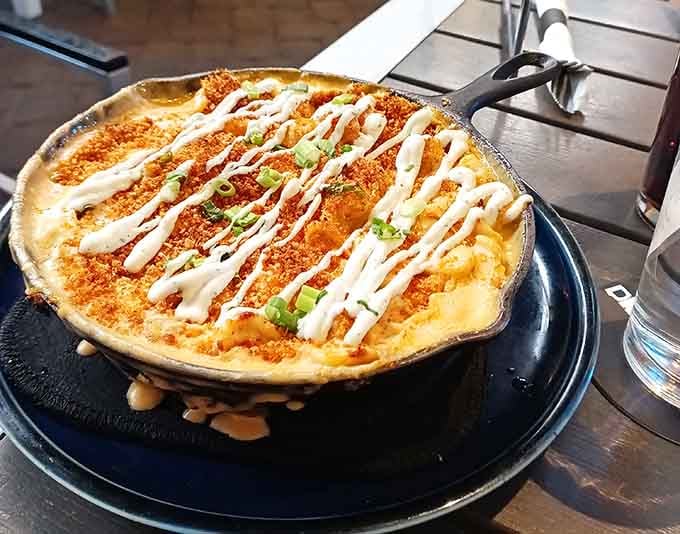 Buffalo chicken mac topped with ranch drizzle because sometimes more really is more and we're okay with that.