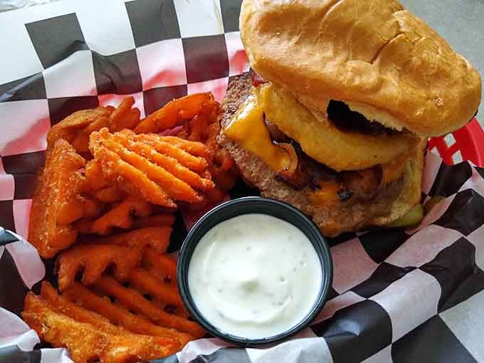 The Stacker Burger arrives with waffle fries and enough melted cheese to make your cardiologist schedule a meeting.