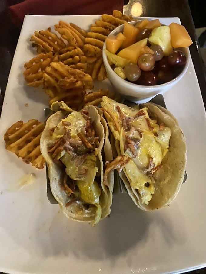 Breakfast tacos with waffle fries and fruit, proving that variety is indeed the spice of morning life.