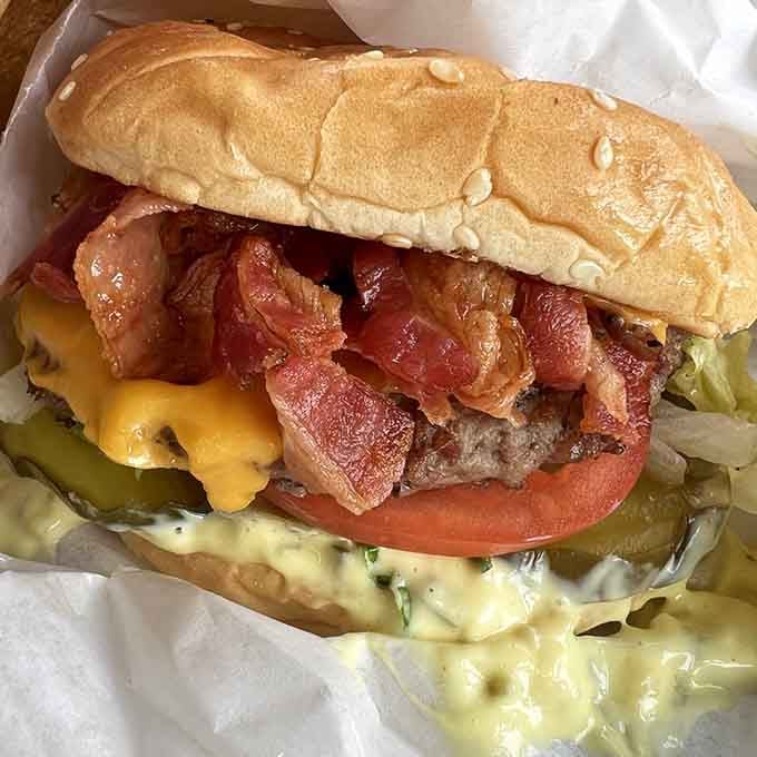 Bacon draped over beef like a delicious blanket, proving that some things really do get better with age and pork.