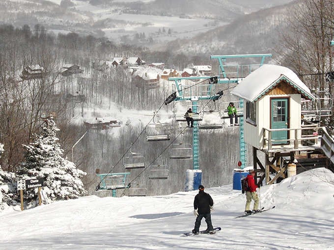 Winter transforms the mountainside into a snowy playground where chairlifts carry dreams of perfect powder runs skyward.