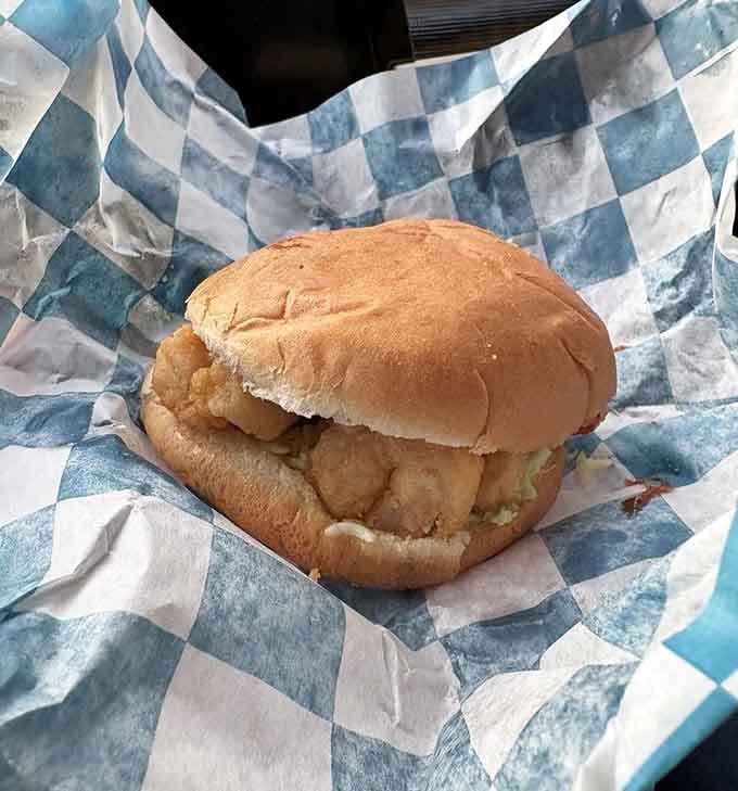 The shrimp burger that coastal Carolina dreams are made of, nestled in checkered paper perfection.