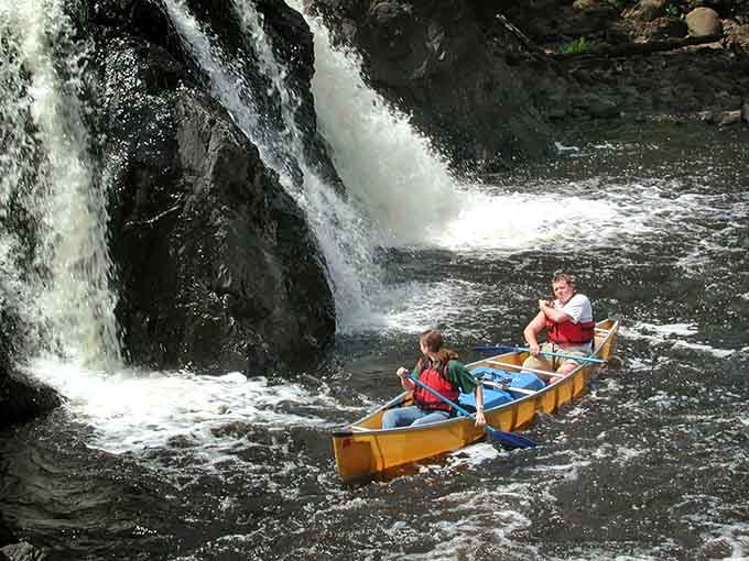 Paddling near a waterfall is nature's way of showing off, and honestly, we're not complaining about it.