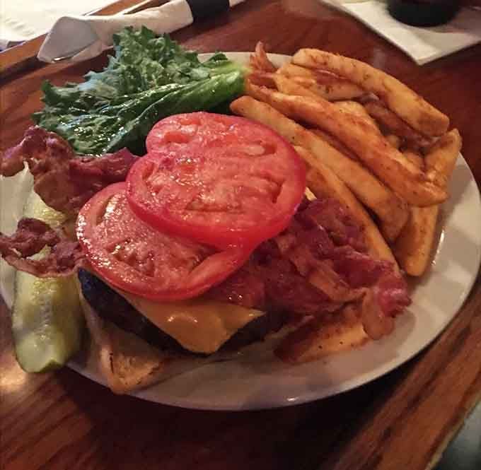This bacon cheeseburger towers like a delicious skyscraper, complete with fries that deserve their own zip code.