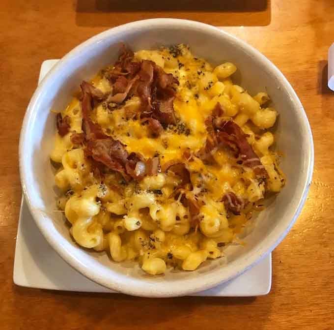 Mac and cheese crowned with crispy bacon bits, because sometimes comfort food needs a standing ovation.