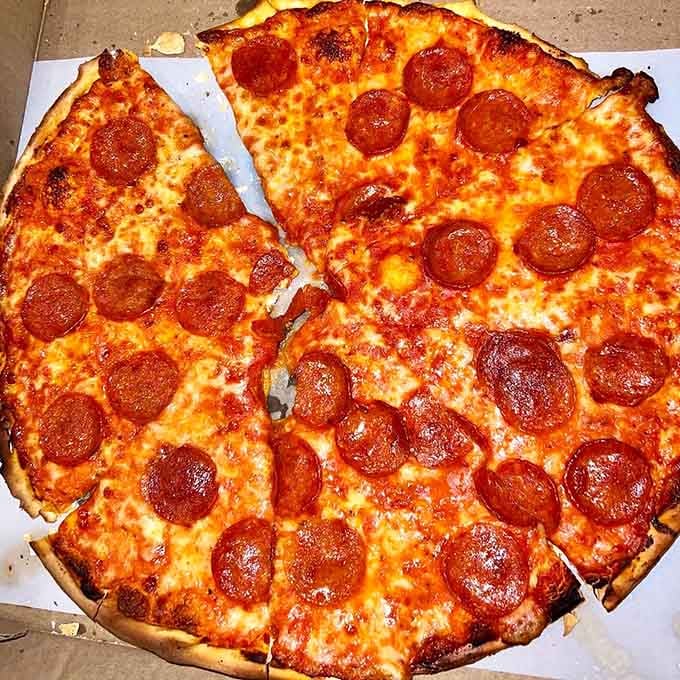 Pepperoni curled to perfection and cheese bubbling golden brown, this is what pizza dreams are made of, plain and simple.