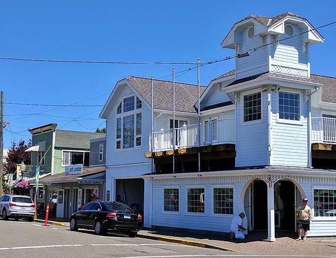 That white Victorian building stands proud on the corner, looking like it stepped straight out of a Mayberry episode with better ocean views.