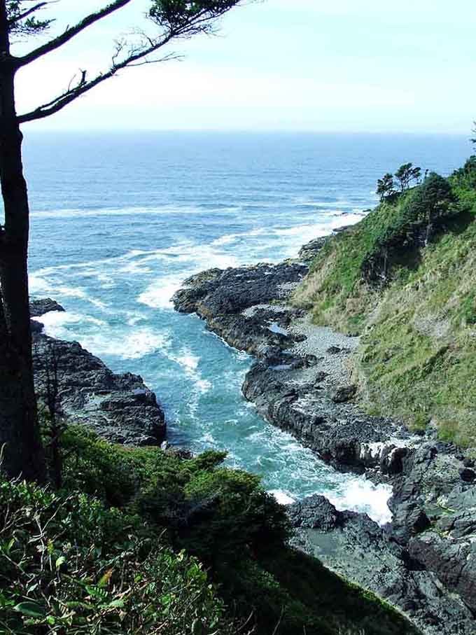 Rocky coastline doing its best dramatic performance, complete with crashing waves and moody green cliffs below.