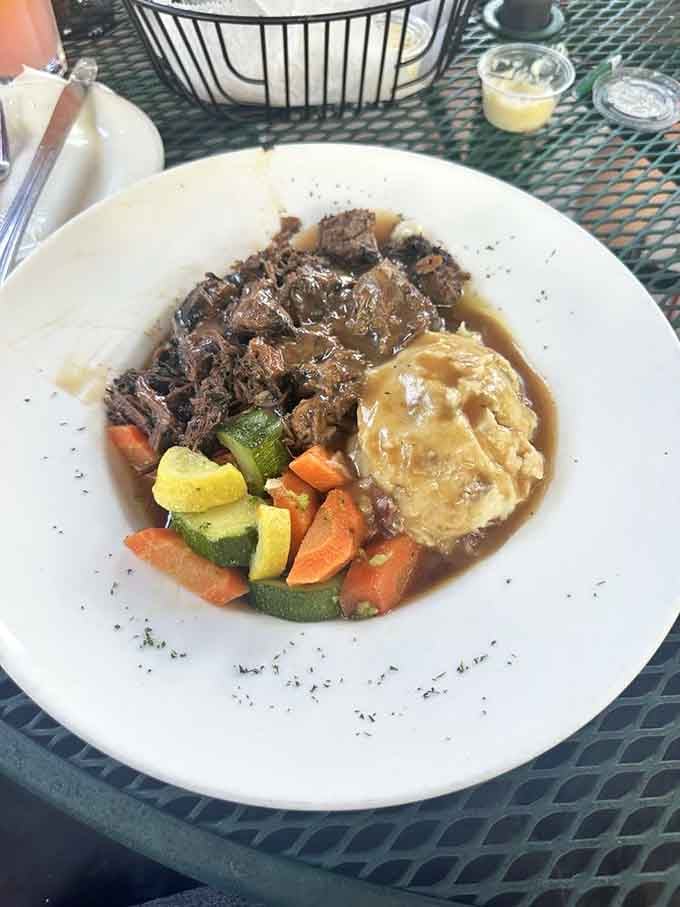Tender pot roast over mashed potatoes with vegetables, comfort food that earned its reputation the hard way.