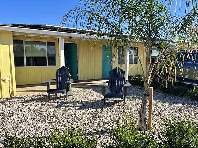 Clean lines meet sunny yellow walls where your room awaits with chairs for contemplating life's important questions.