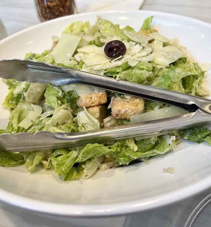 Even the Caesar salad gets the royal treatment, crisp romaine with shaved cheese that could convert any pizza purist.