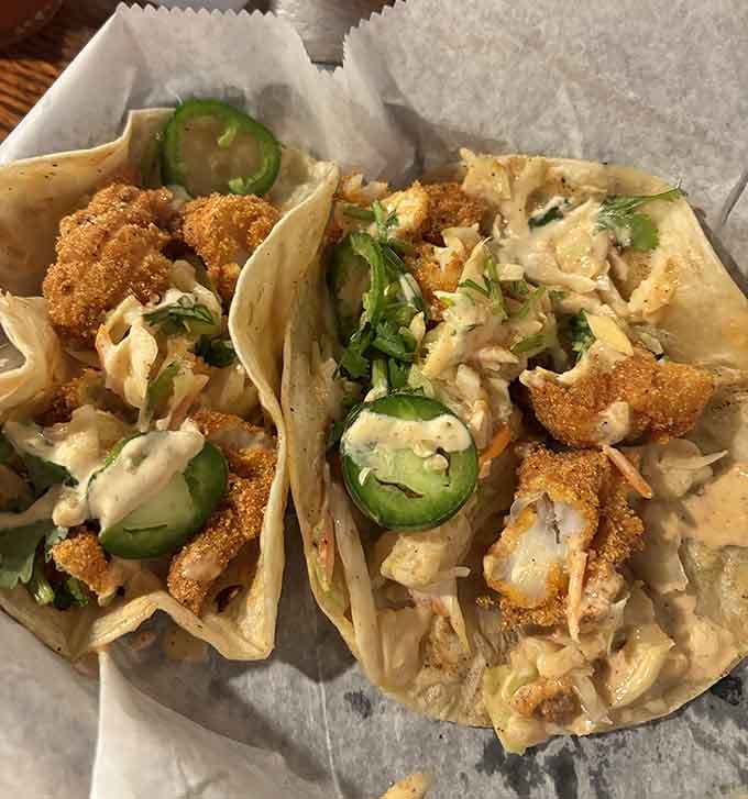 Crispy catfish tacos topped with slaw prove that landlocked Illinois knows its way around seafood done right.