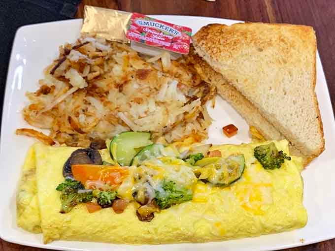A fluffy omelet loaded with vegetables proves breakfast done right never goes out of style, no matter the hour.