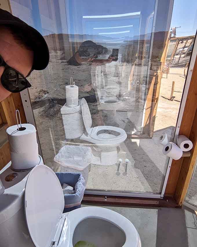 Inside the glass outhouse, privacy becomes a philosophical question rather than an actual feature of the experience.