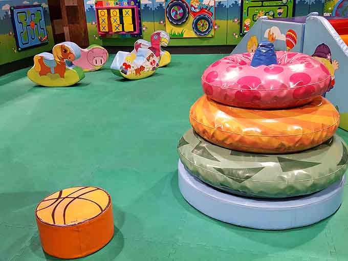 Soft play equipment in rainbow colors keeps toddlers entertained without the chaos of mixing age groups.