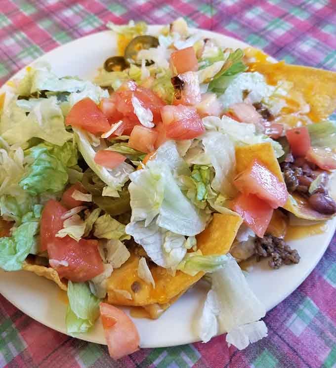 When nachos meet pizza, beautiful things happen, especially when lettuce and tomatoes join the party.