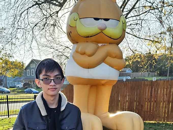 Proof that Garfield statues make everyone smile, regardless of age or eyewear preference on display here.