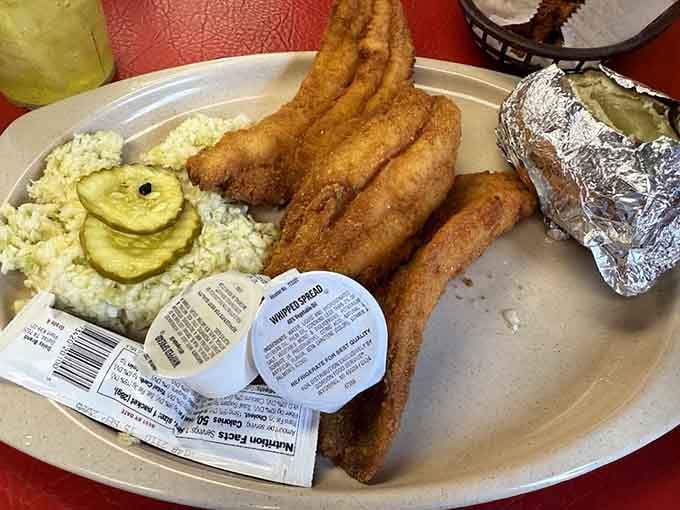 Fried catfish so perfectly golden it practically glows, served with sides that understand the assignment of Southern comfort.