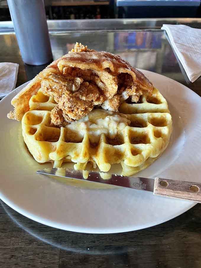 Fried chicken perched atop fluffy waffles like it's claiming its rightful throne in the breakfast hall of fame forever.