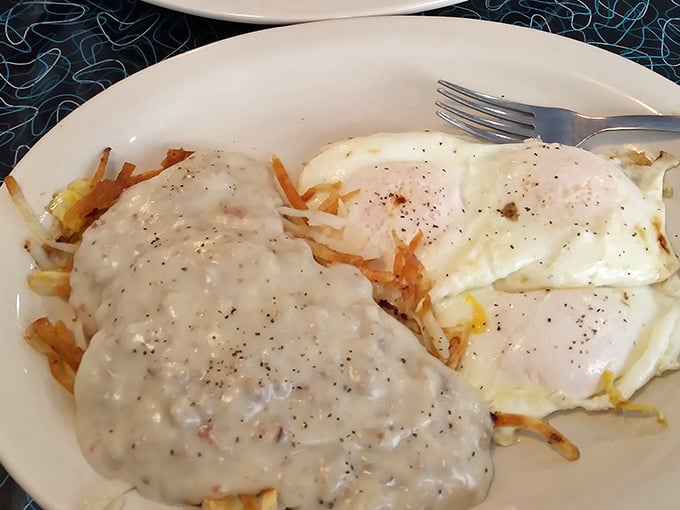 Chicken fried steak smothered in gravy over hash browns, the kind of breakfast that makes you understand why people wake up early.