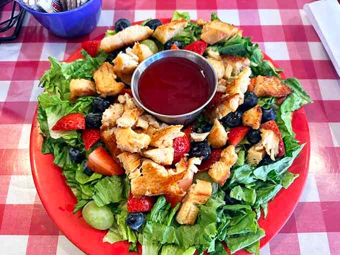 This colorful salad loaded with crispy chicken, fresh berries, and strawberries shows that even retro diners embrace healthy options.