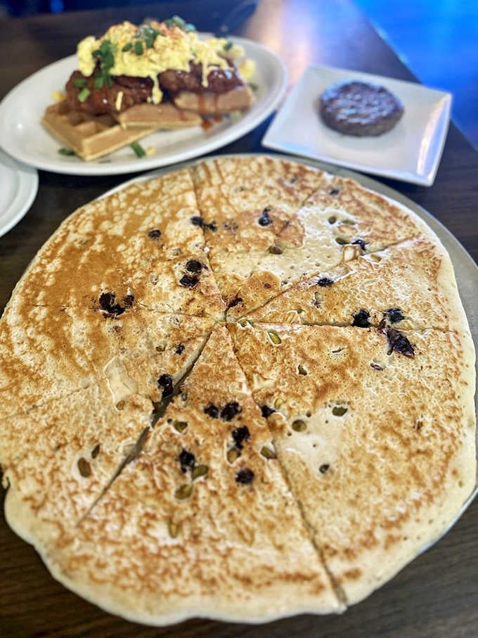 The Blueberry Pistachio Pancake arrives like a delicious UFO, studded with berries and nuts across its golden surface.