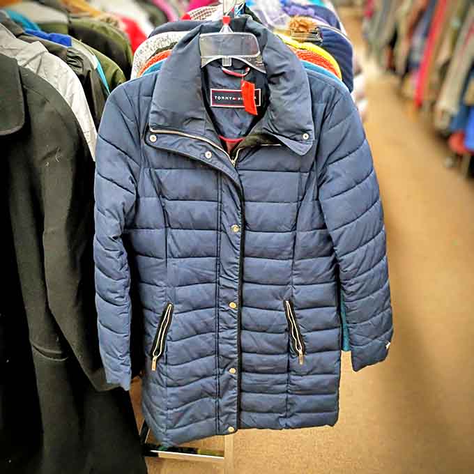 Winter coats hanging like a rainbow of warmth, proving Minnesota style comes in every color imaginable.