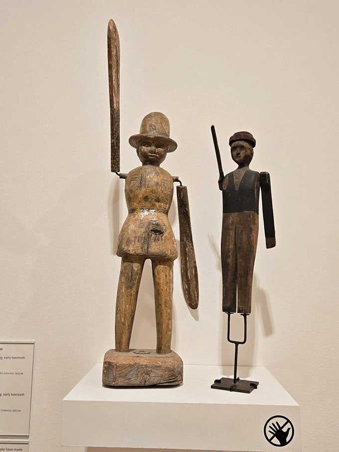 Folk art figures standing proud with their walking sticks, reminding us that creativity doesn't require a degree.