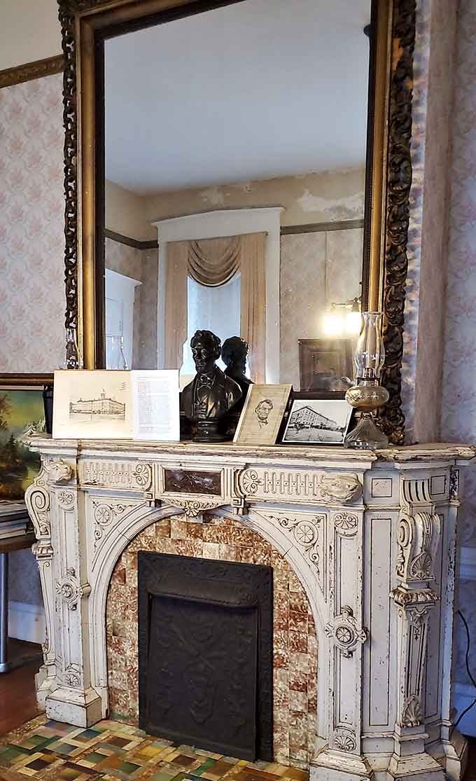 Victorian elegance meets ornate craftsmanship in this fireplace, complete with mirror that may reflect more than just your face.