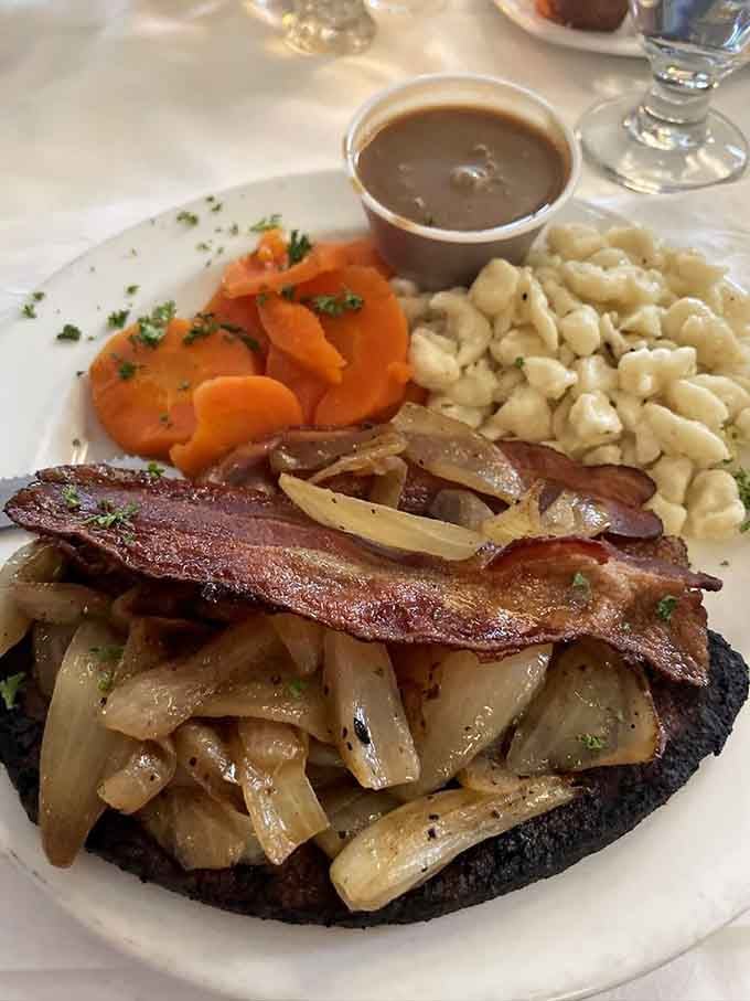 Liver and onions topped with bacon, because sometimes traditional German cooking just knows exactly what your soul needs right now.