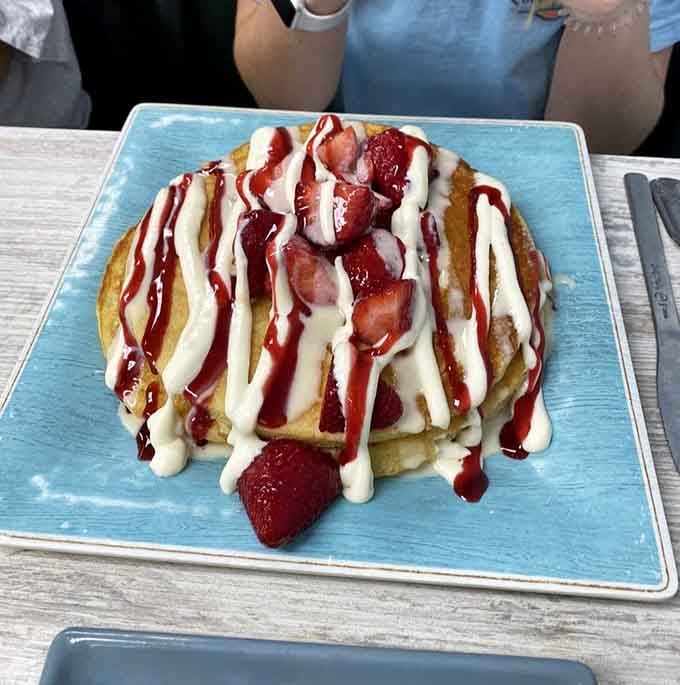 Strawberry cheesecake for breakfast isn't rebellion, it's enlightenment served on a turquoise plate with raspberry drizzle.