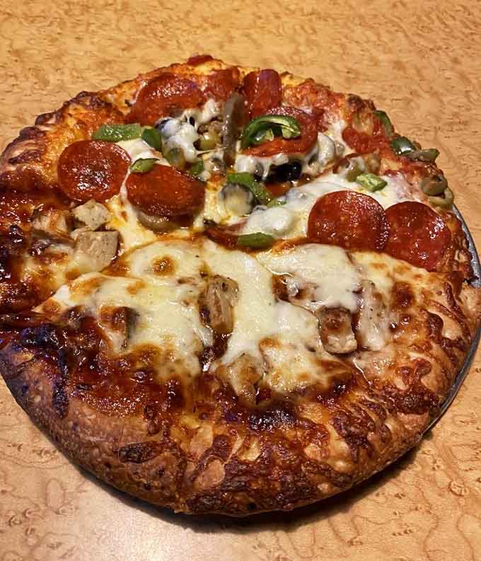 One pizza loaded with everything, another keeping it simple; both looking like they mean serious business on your taste buds.